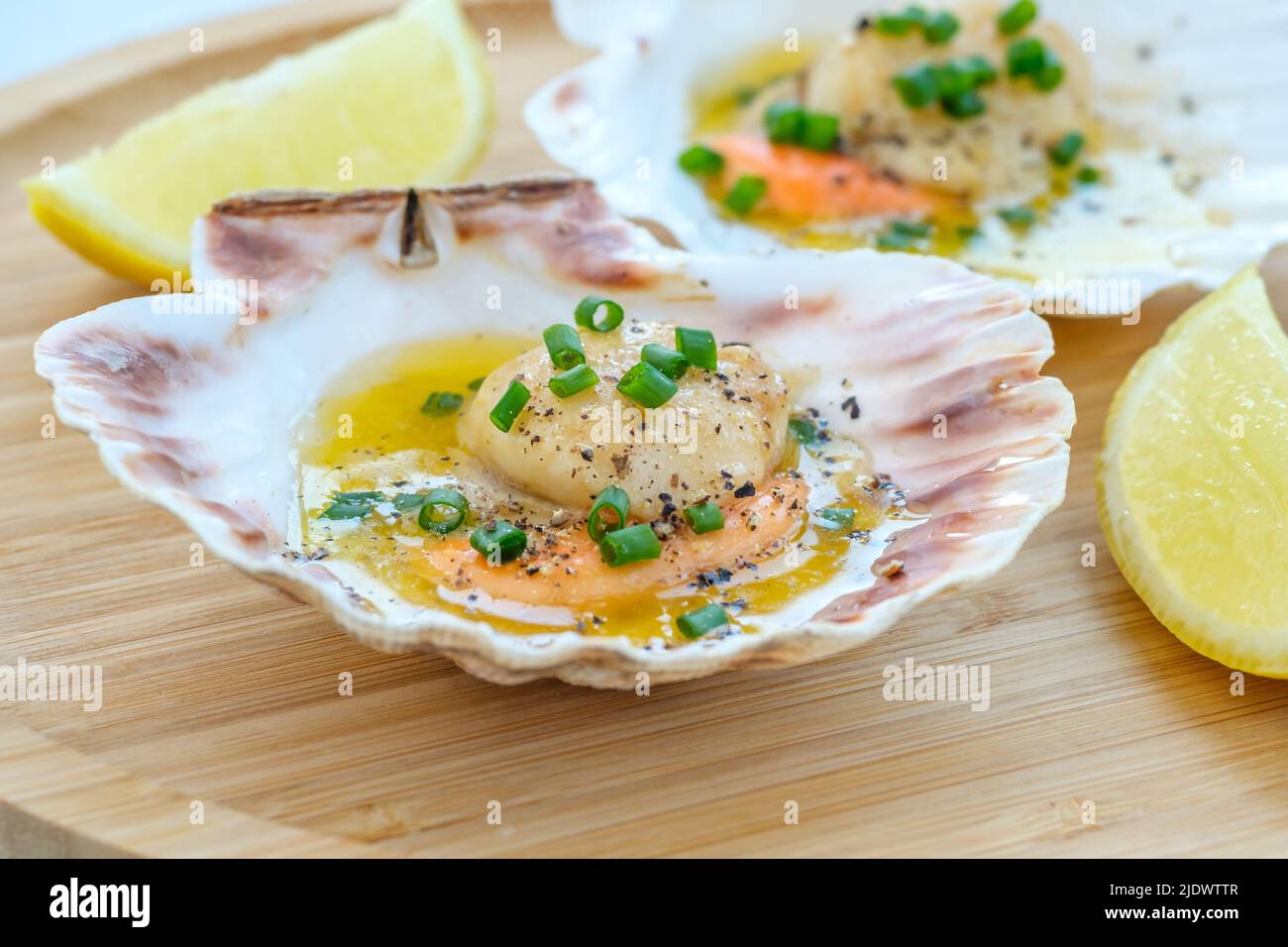 King scallop with roe and butter sauce in shell Stock Photo - Alamy