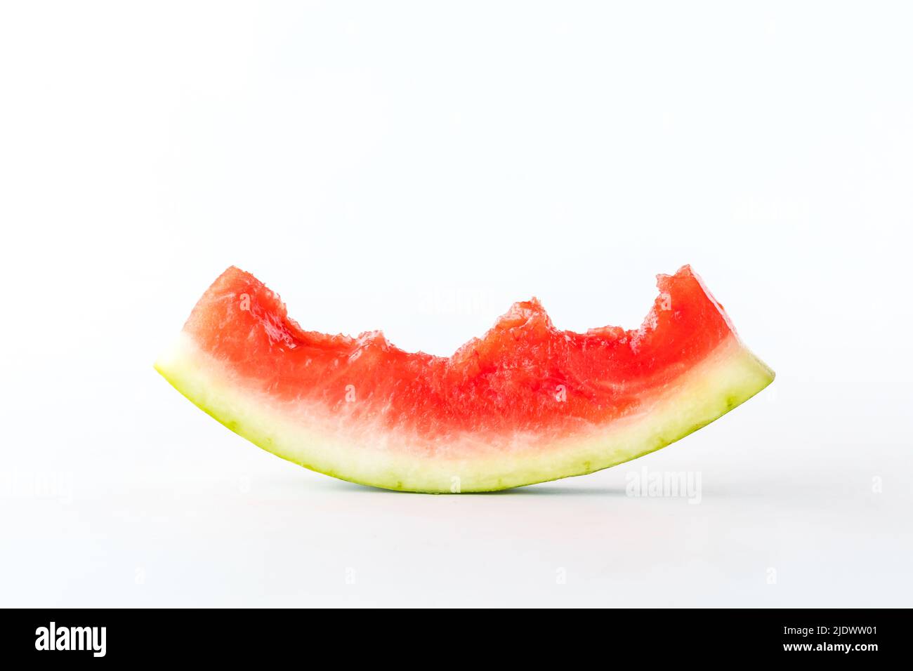 Close up of a mostly eaten watermelon slice isolated against a white ...