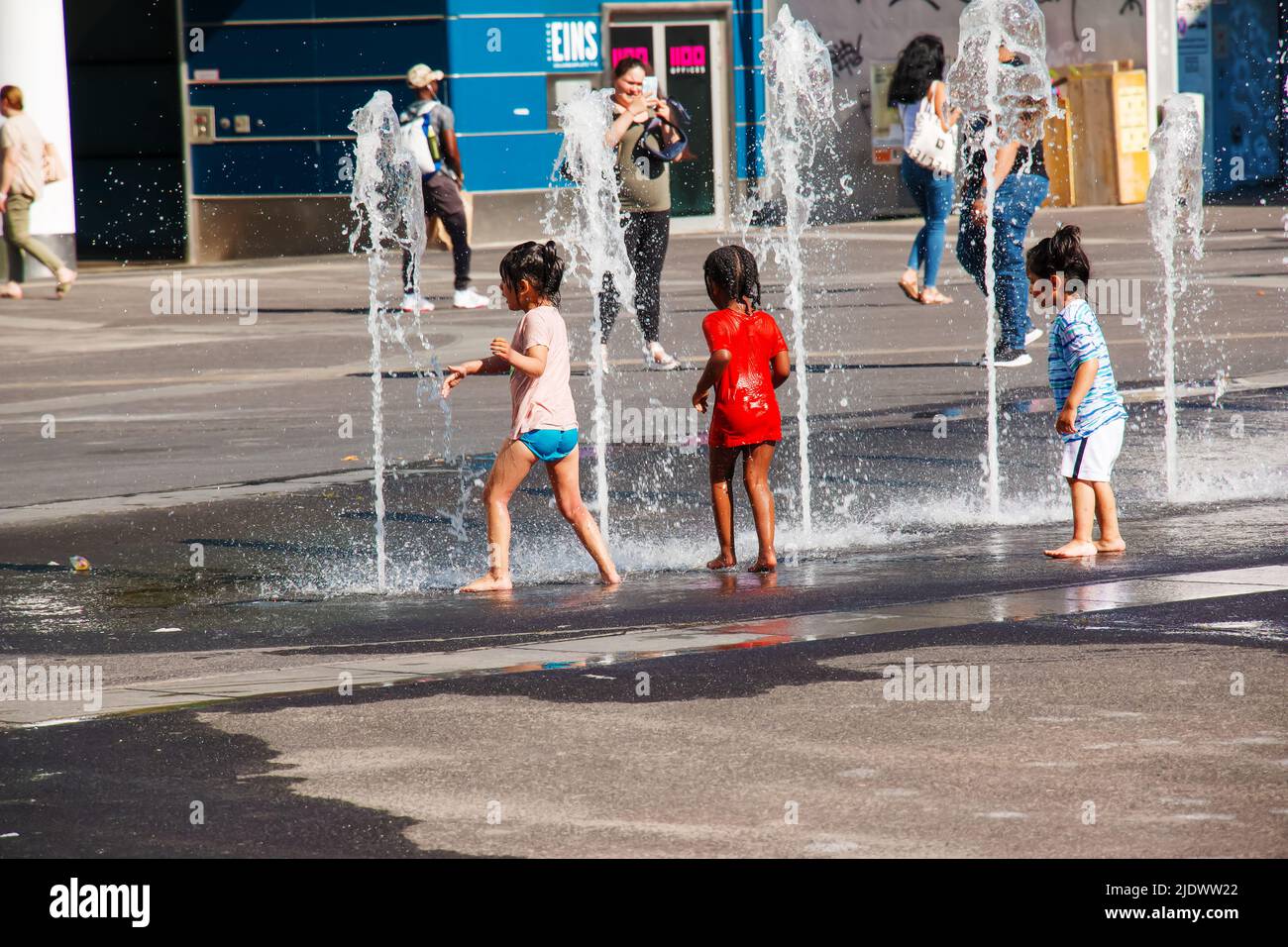Vienna, Austria - 06.13.2022: Children frolic in the jets of the city ...