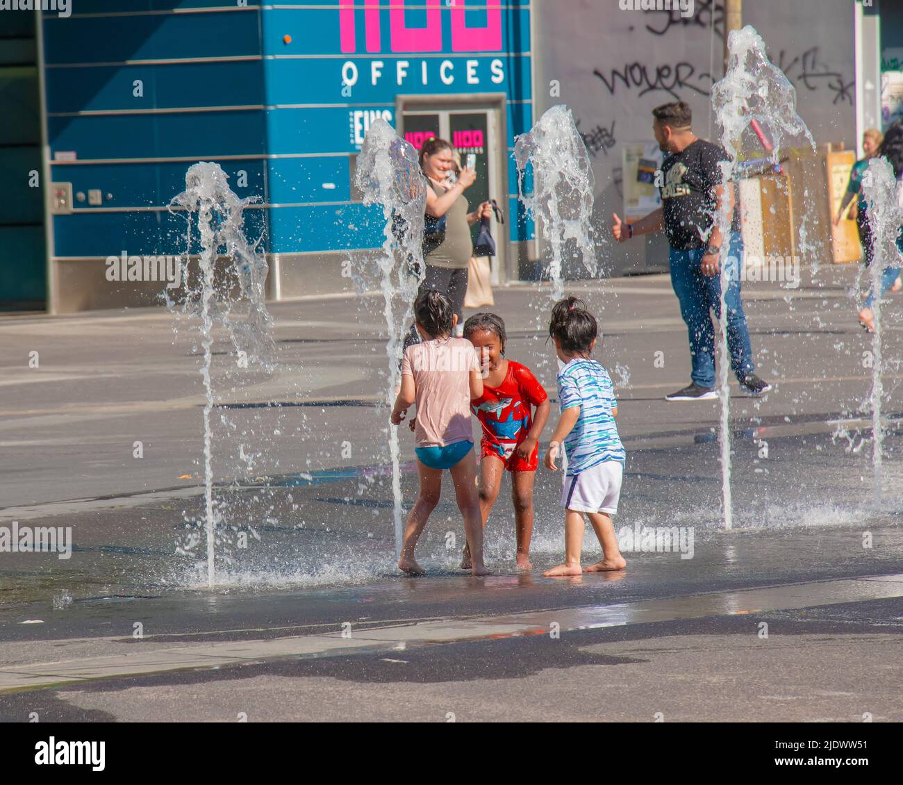 Vienna, Austria - 06.13.2022: Children frolic in the jets of the city ...