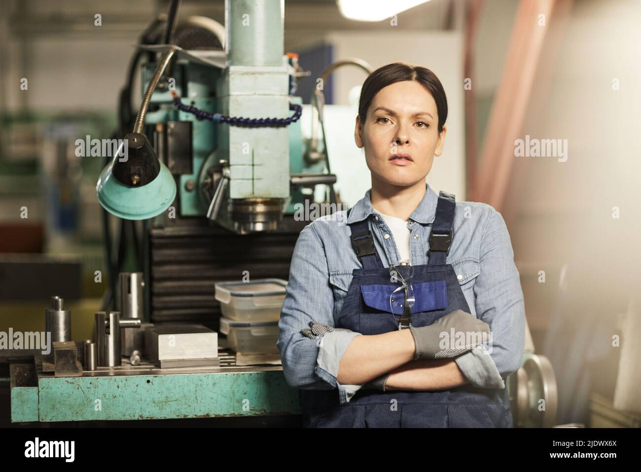 Portrait of content confident attractive female lathe worker in ...