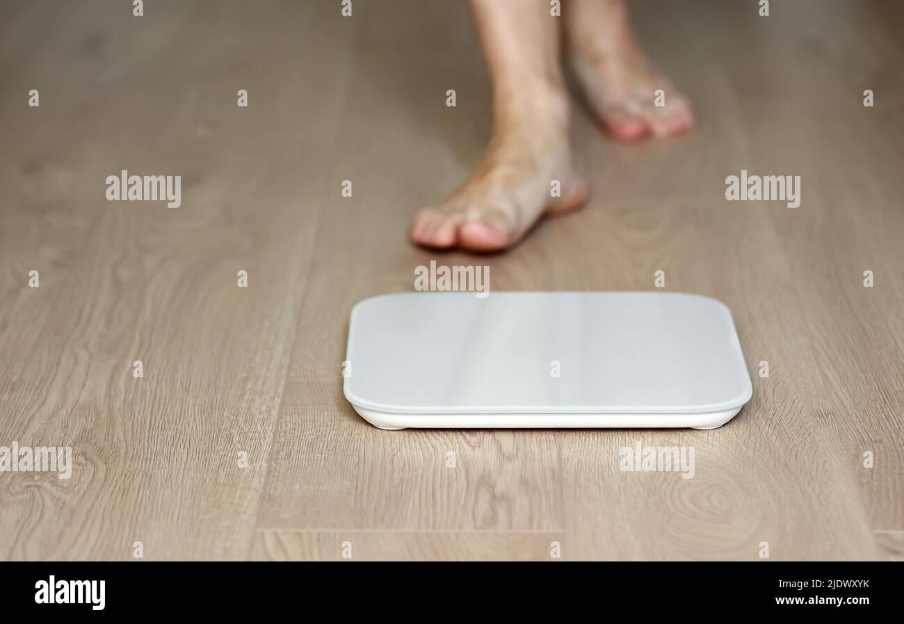 Man walking on scales measure weight. male wal checking BMI weight loss ...