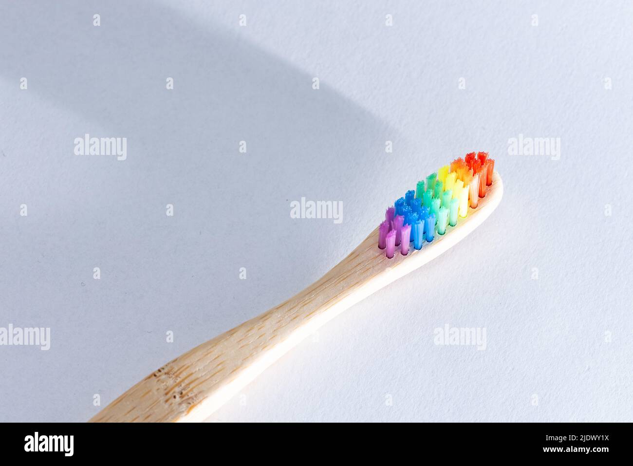Toothbrush in rainbow colors. Ecological everyday objects. Wooden ...
