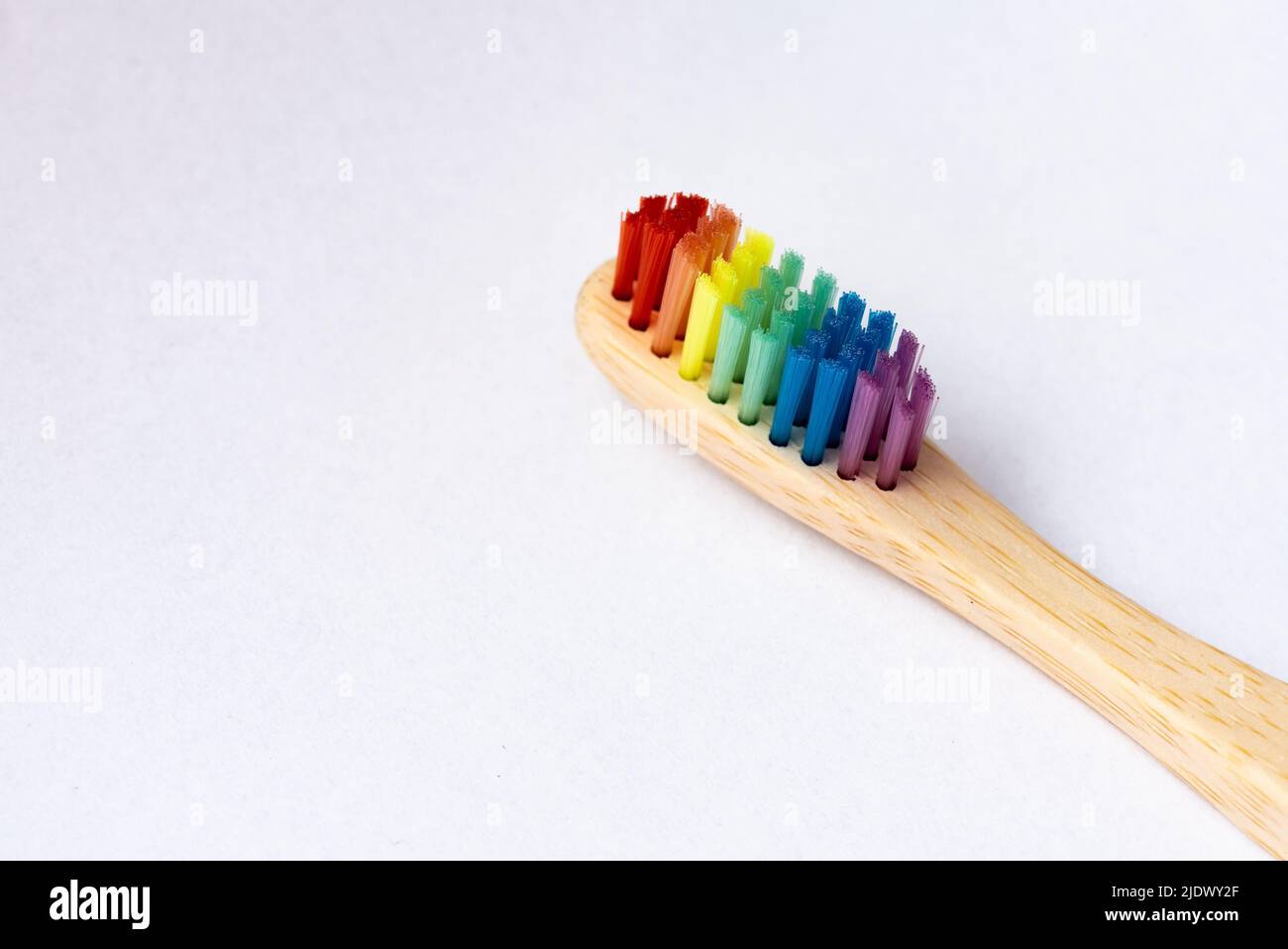 Toothbrush in rainbow colors. Ecological everyday objects. Wooden ...