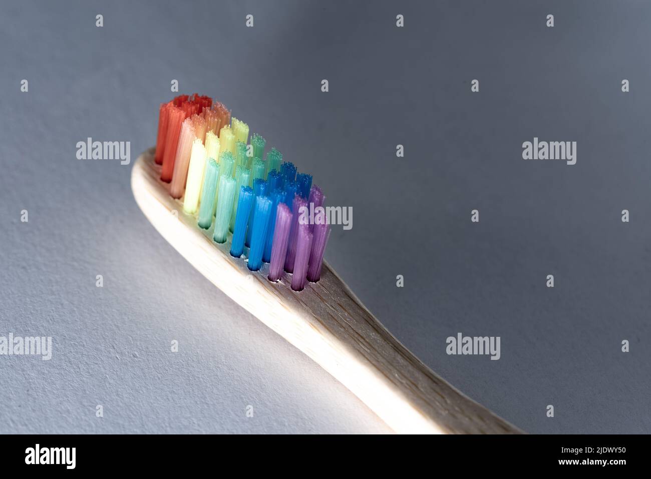 Toothbrush in rainbow colors. Ecological everyday objects. Wooden ...