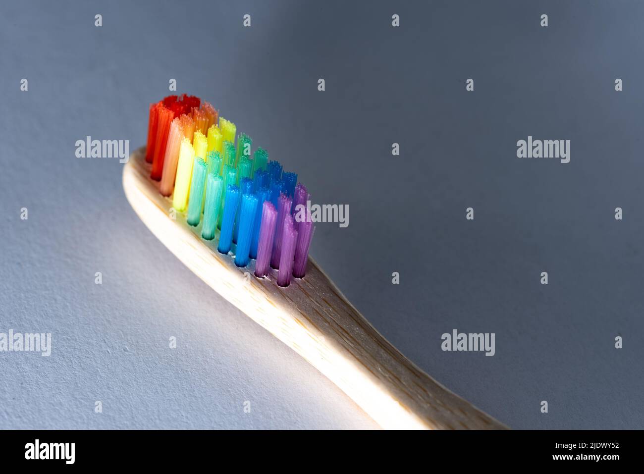 Toothbrush in rainbow colors. Ecological everyday objects. Wooden ...