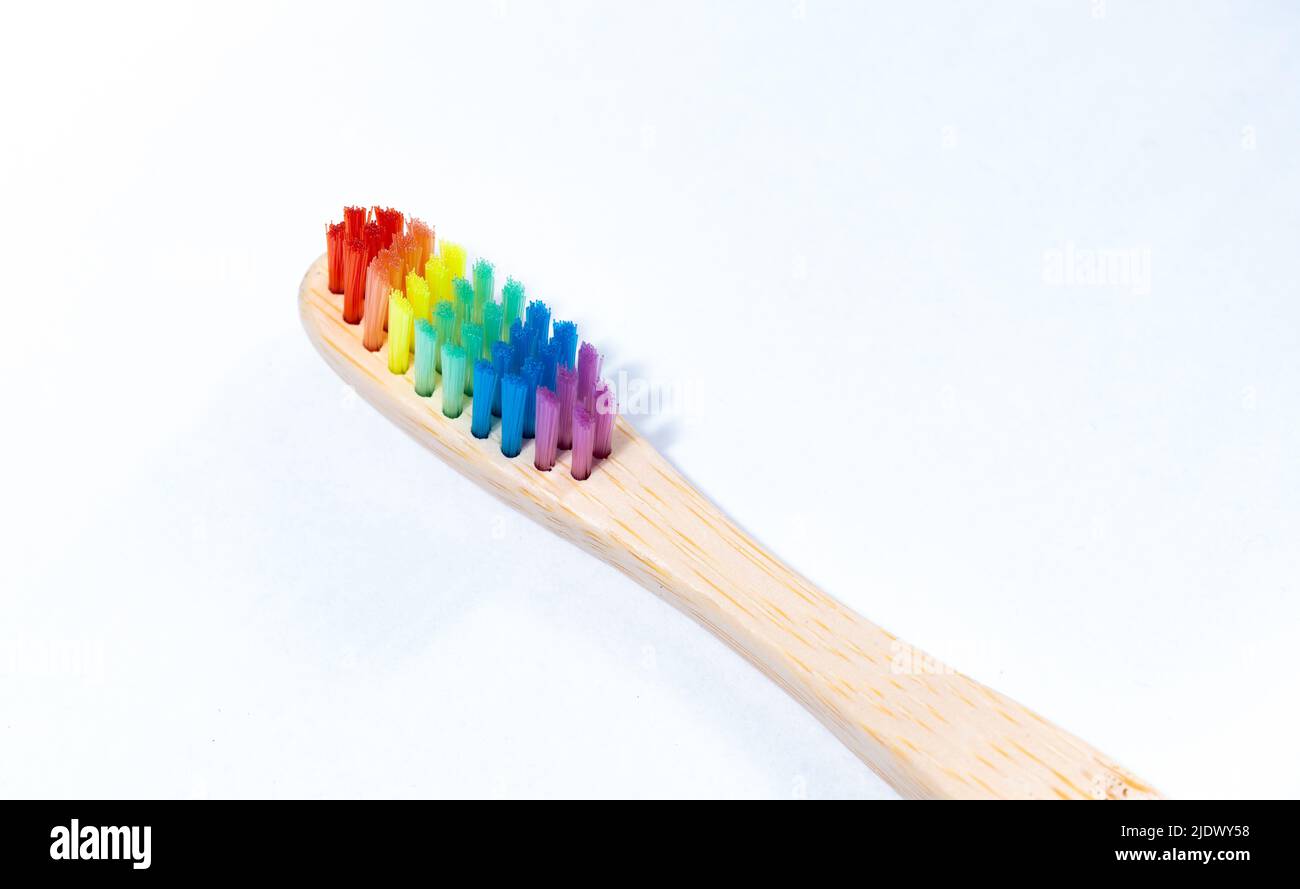 Toothbrush in rainbow colors. Ecological everyday objects. Wooden ...