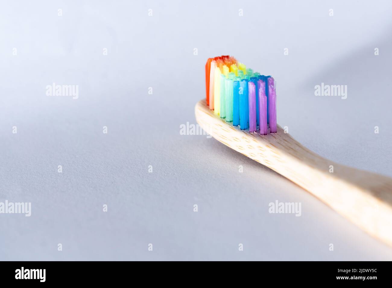 Toothbrush in rainbow colors. Ecological everyday objects. Wooden ...