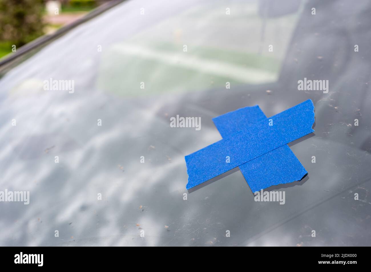 Tape covering a chip on a car windshield Stock Photo - Alamy