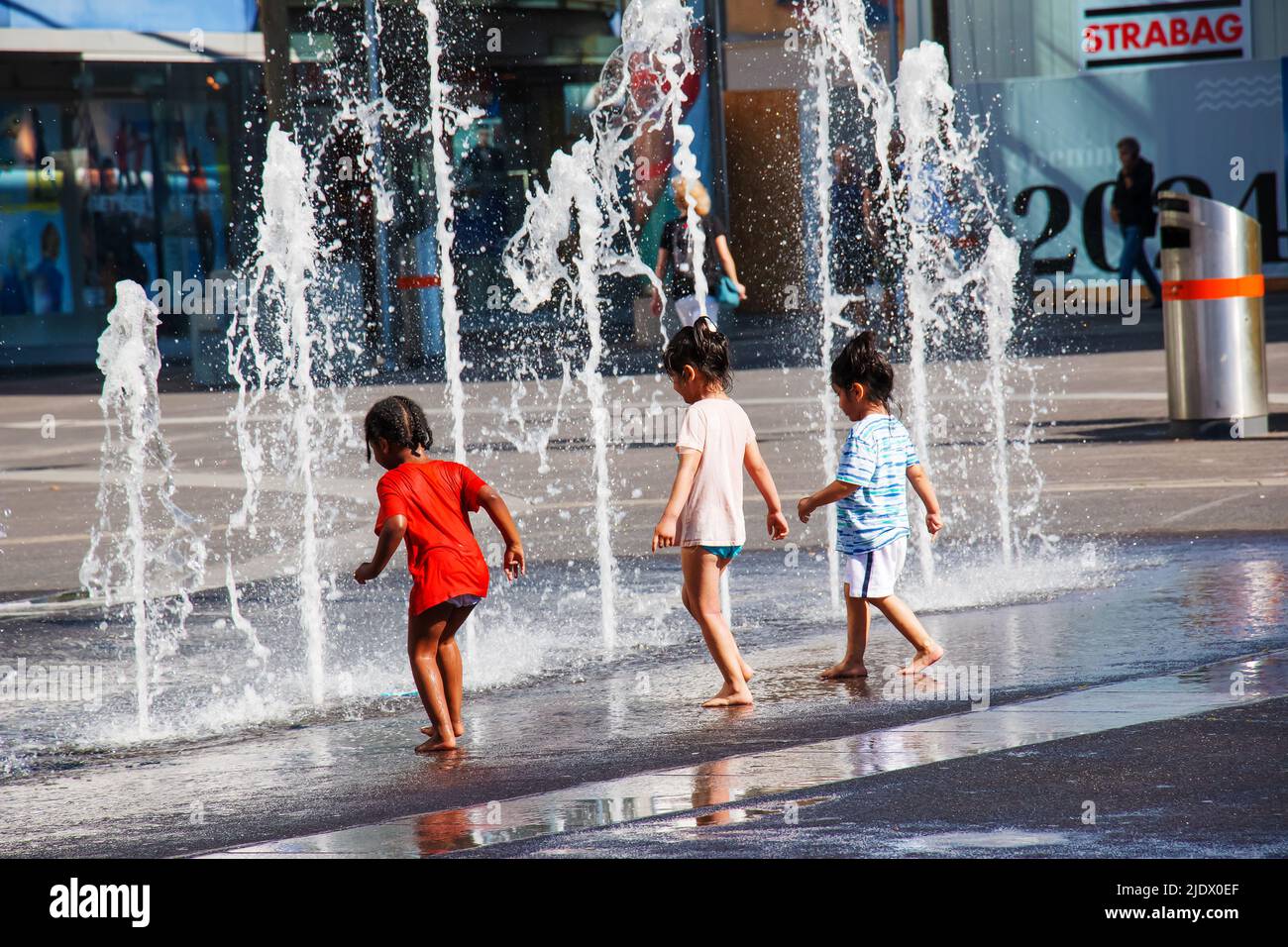 Vienna, Austria - 06.13.2022: Children frolic in the jets of the city ...