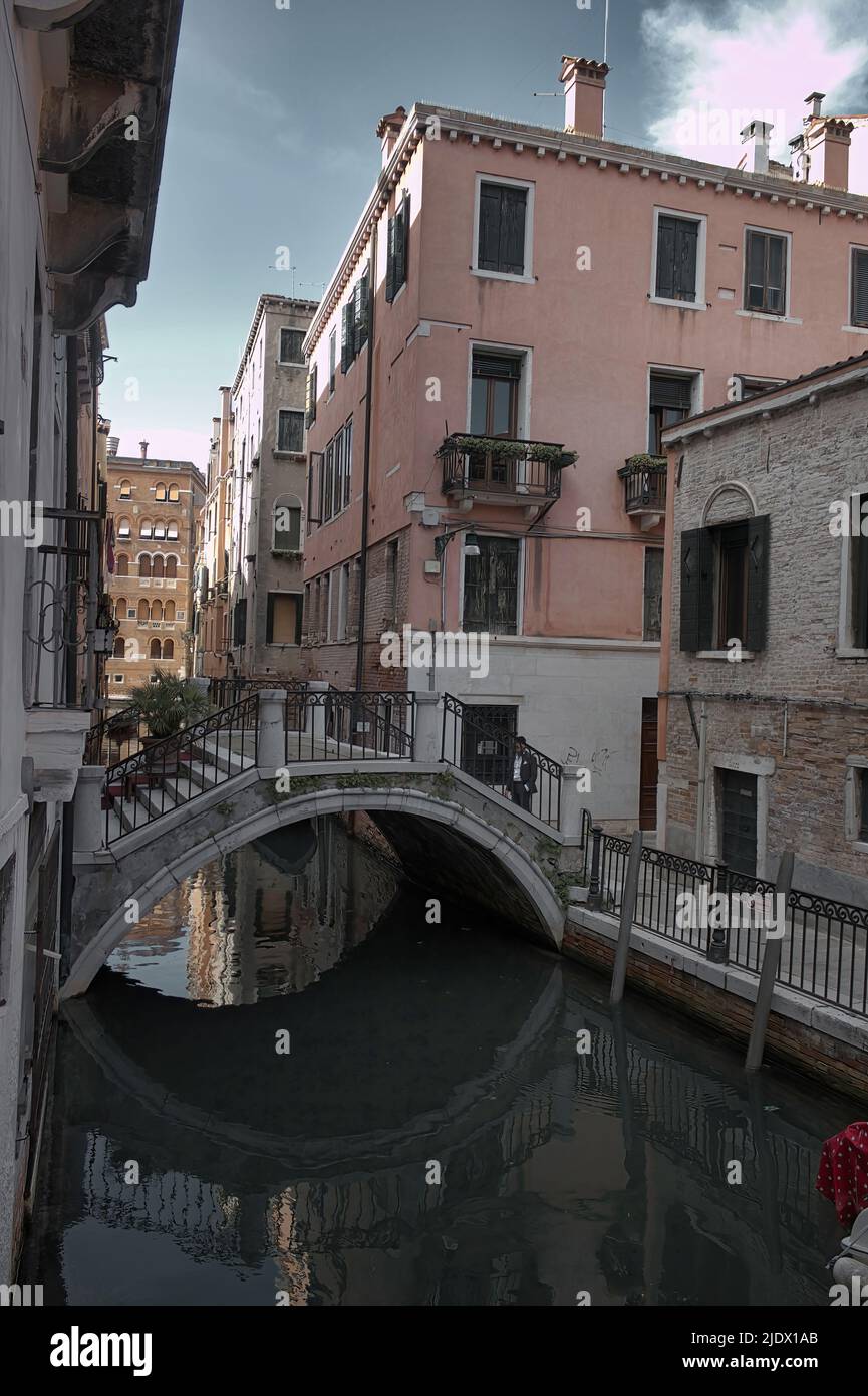 Scenic arc bridge over small canal in residential neighborhood in ...