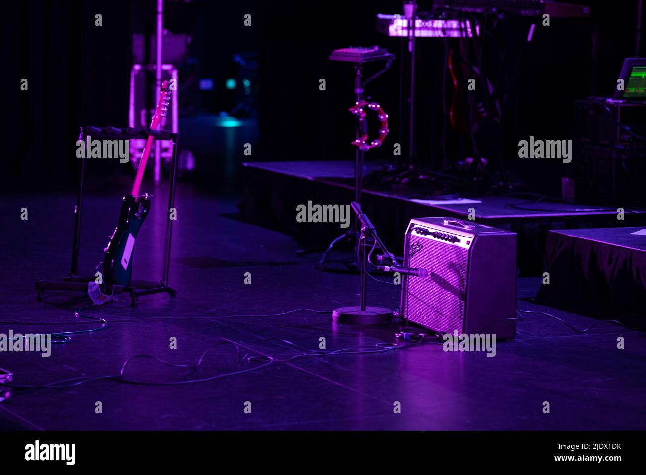 Fender Amplifier and guitar set up on stage under pruple stage lighting ...