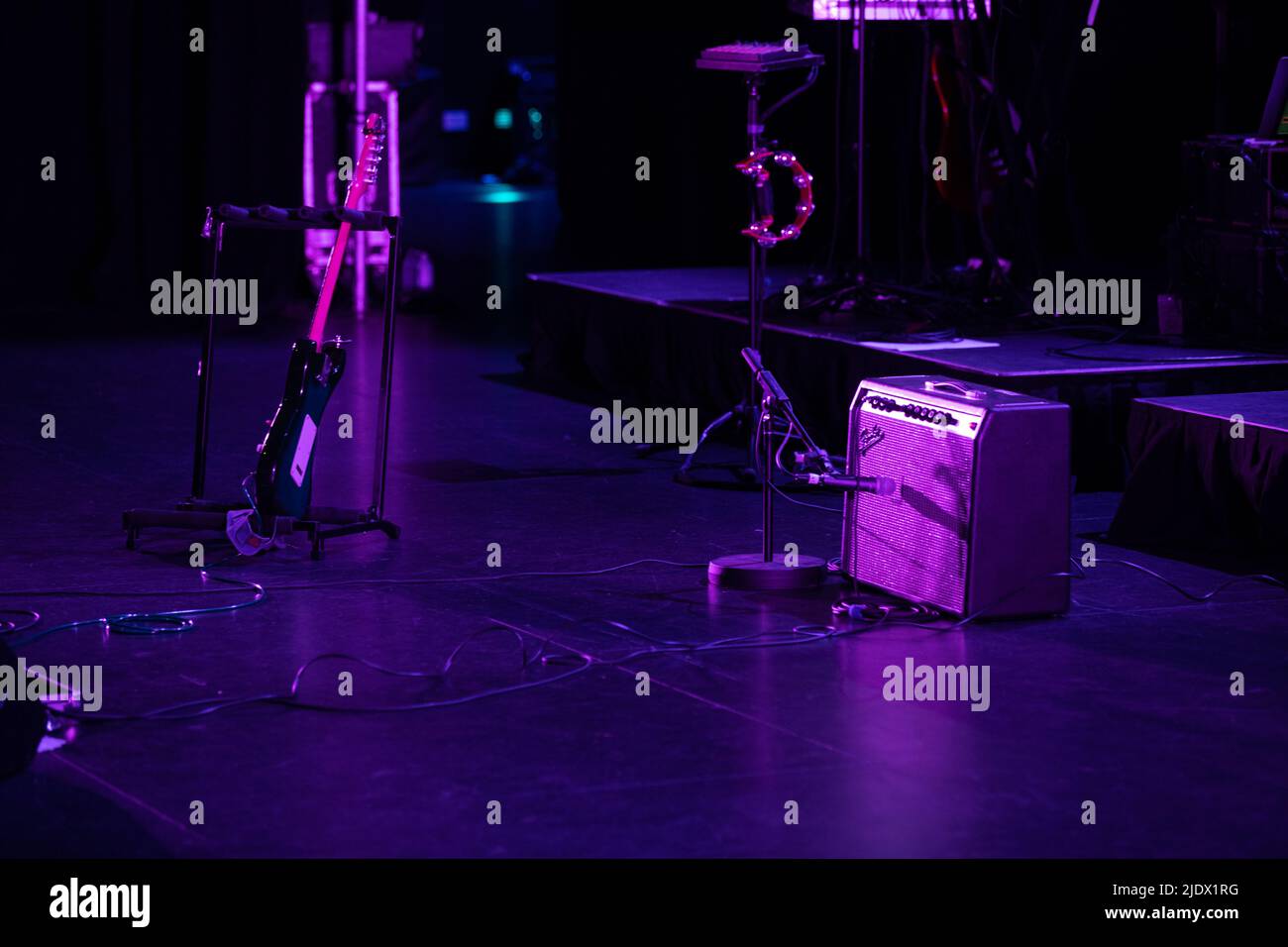 Fender Amplifier and guitar set up on stage under pruple stage lighting ...