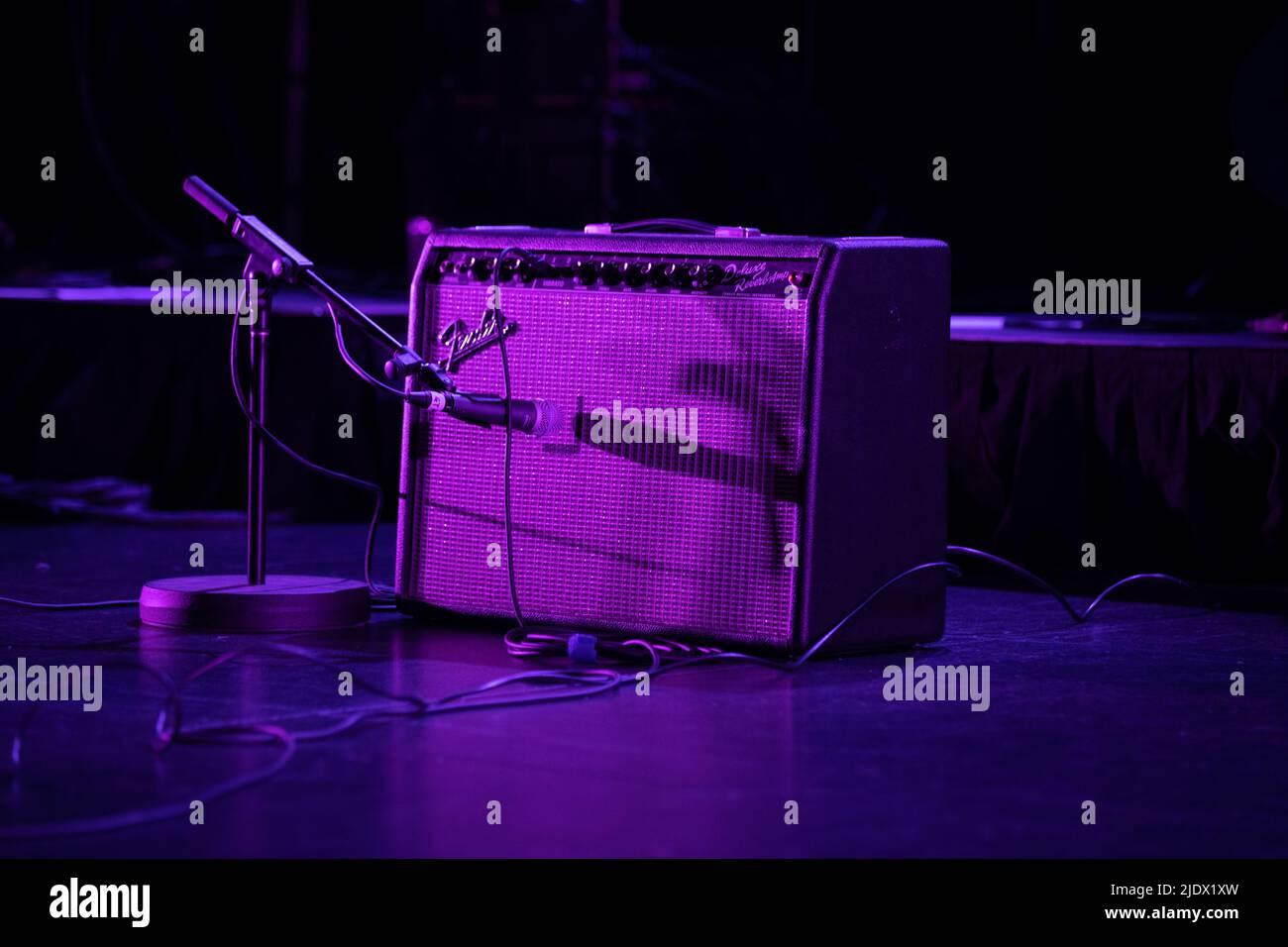 Fender Amplifier and guitar set up on stage under pruple stage lighting ...