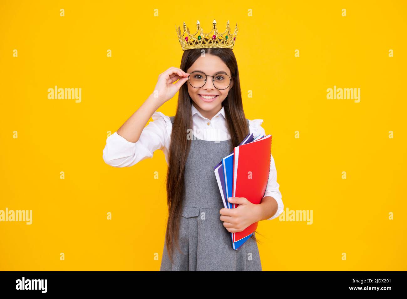 Excited teenager princess in school uniform and crown celebrating ...