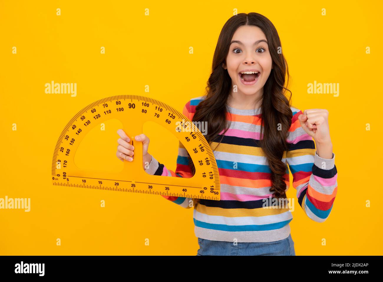 Amazed teenager. School girl holding measure for geometry lesson ...