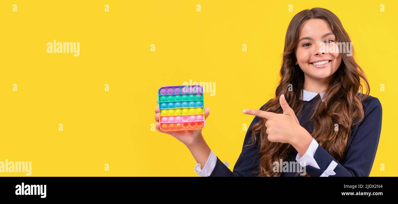 happy child point finger on popit silicone sensory fidget game, pop it ...