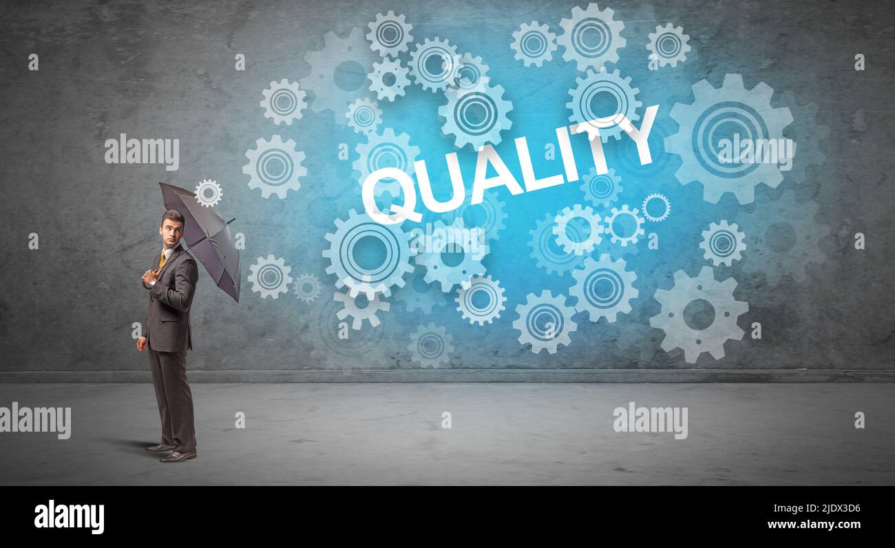 Businessman defending with umbrella concept Stock Photo - Alamy