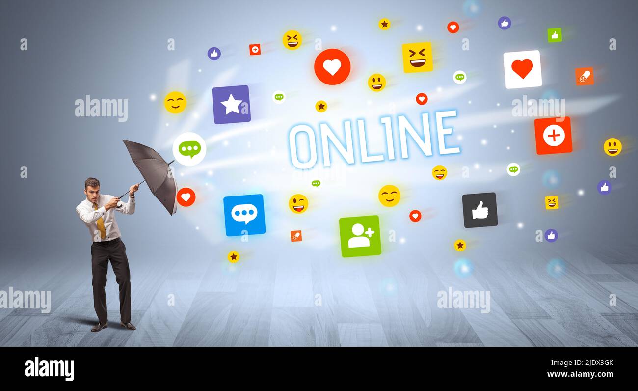 businessman defending with umbrella from social media Stock Photo - Alamy