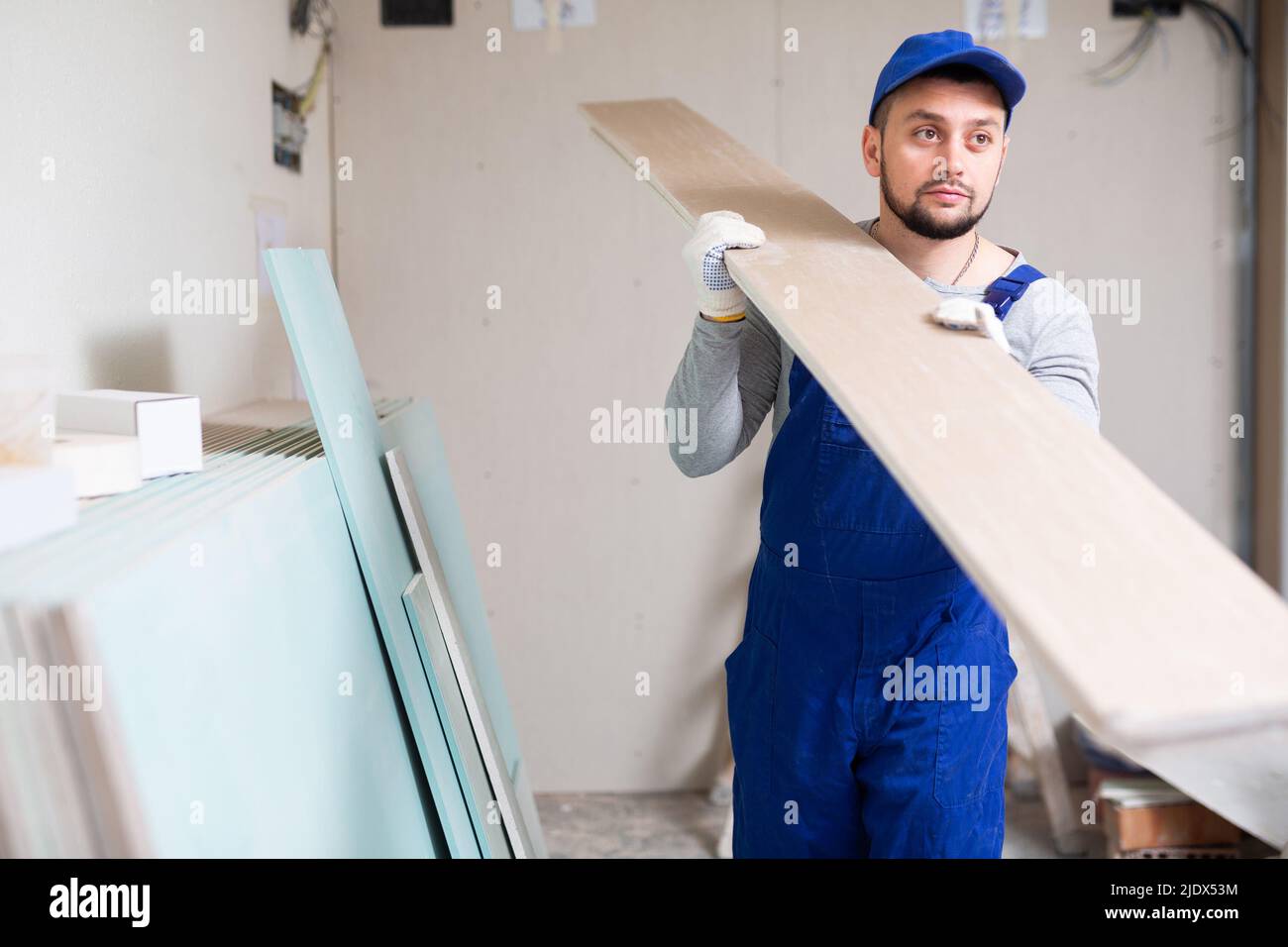 Worker carrying construction materials at renovating object Stock Photo ...