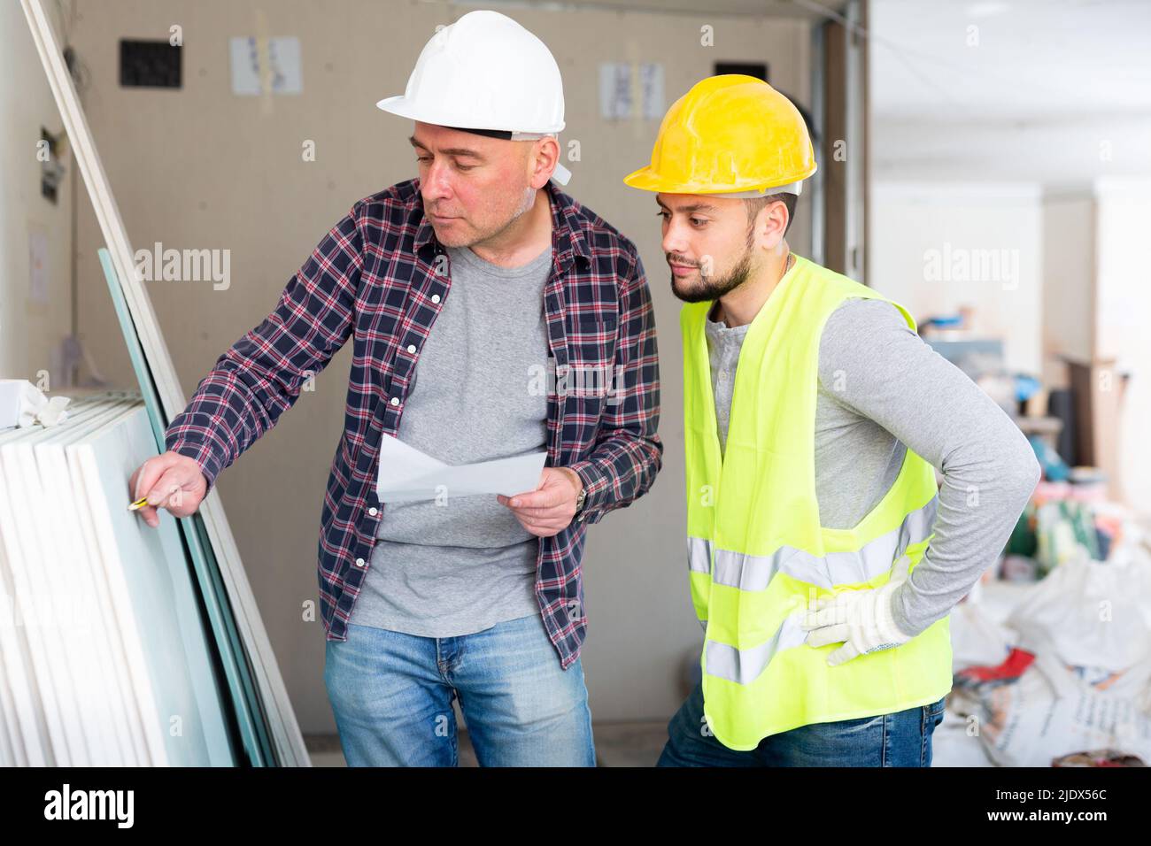 Civil engineer giving instructions to foreman in building under ...
