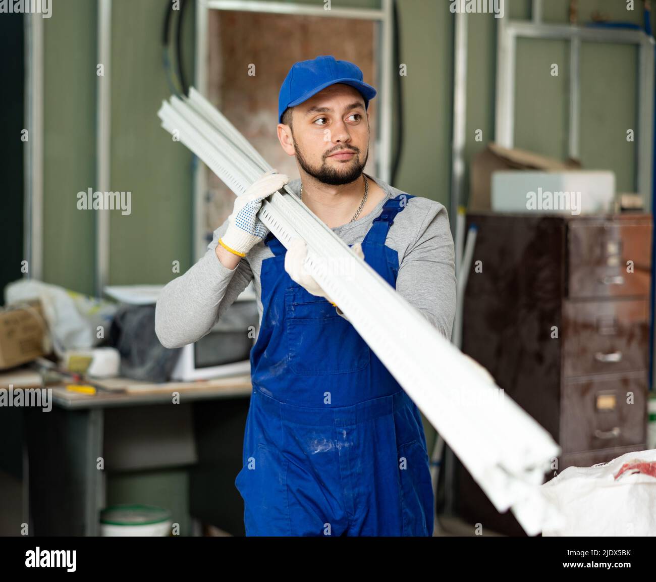Worker carrying construction materials at renovating object Stock Photo ...