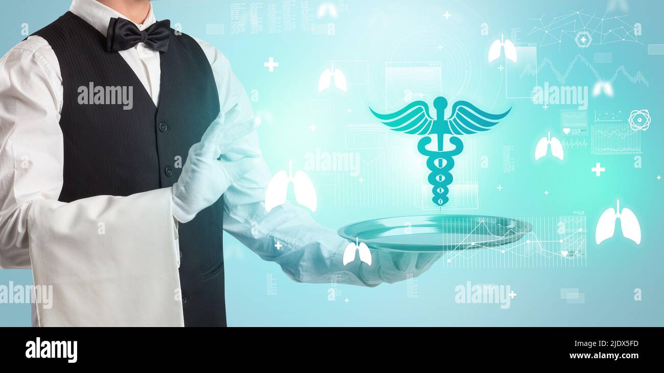 Handsome young waiter in tuxedo holding healthcare icons on tray Stock ...
