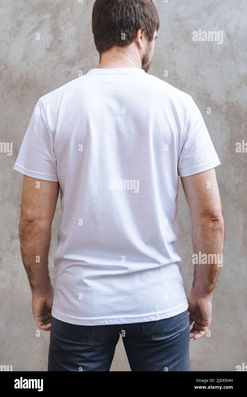 Back view man in a blank white casual t-shirt. Young boy on a ...