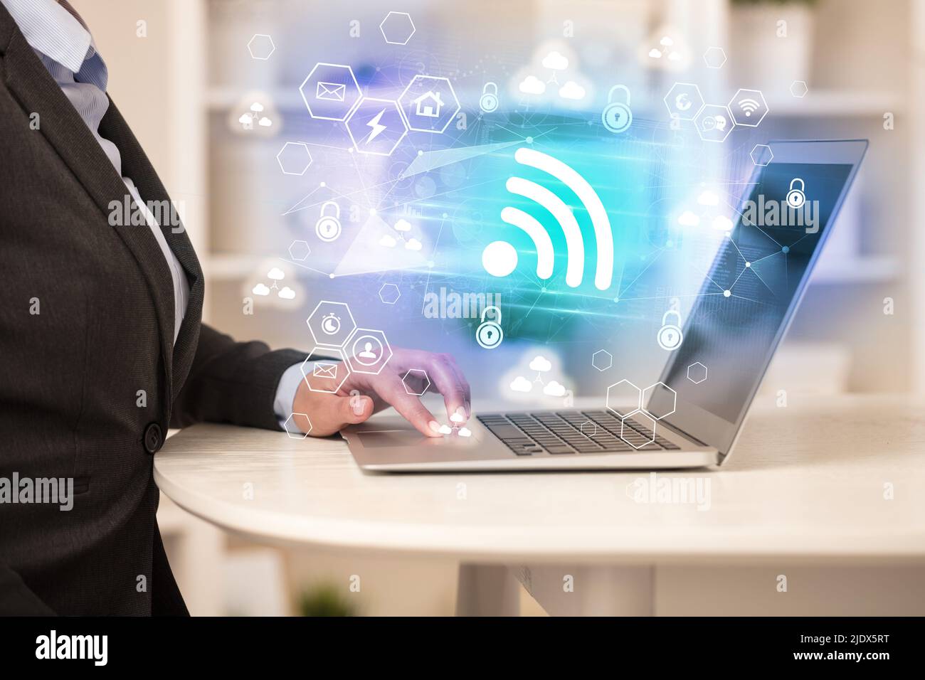 Hands working on laptop with digital icons Stock Photo - Alamy