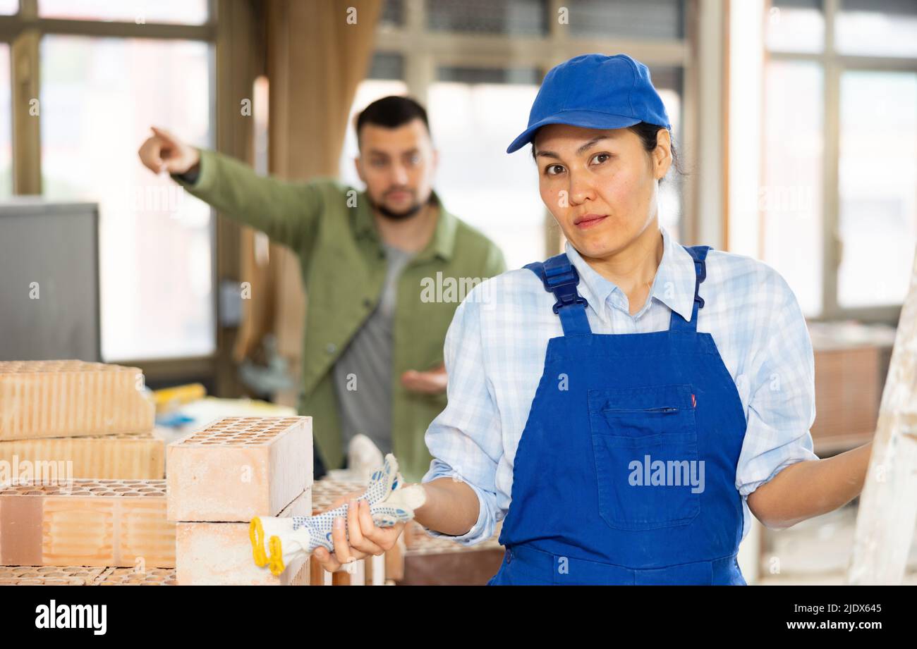 Confused female builder having conflict with construction manager Stock ...