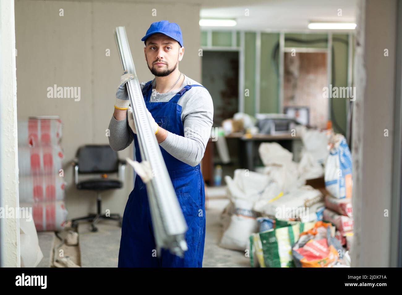 Worker carrying construction materials at renovating object Stock Photo ...