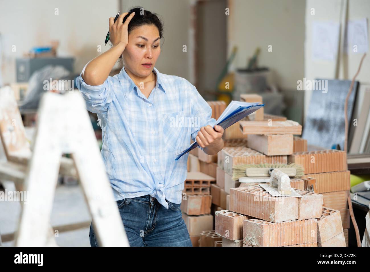 Frustrated woman architect on indoor construction site Stock Photo - Alamy