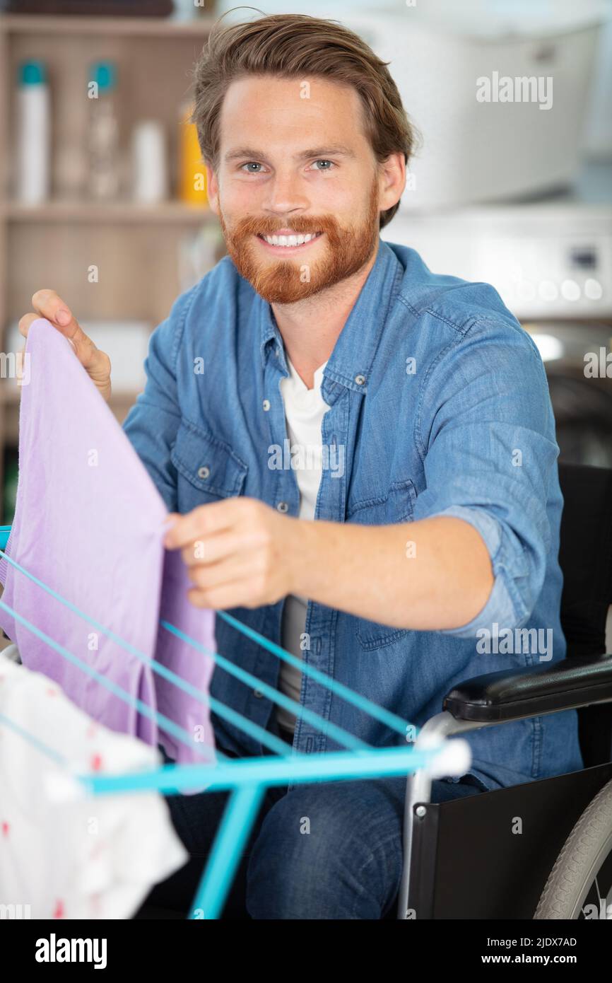 disabled man on wheelchair doing laundry Stock Photo - Alamy