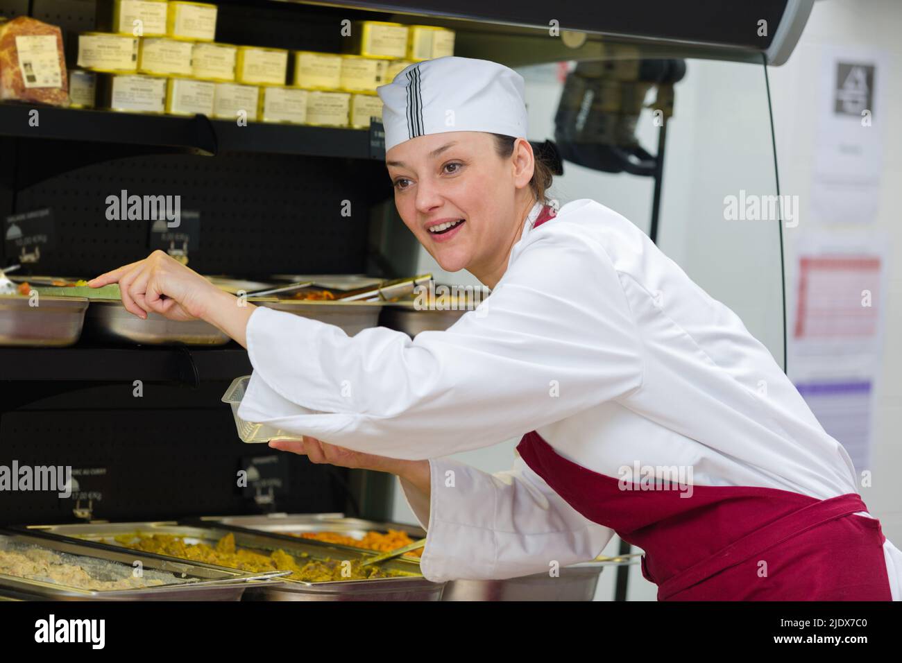 buffet female worker servicing food in cafeteria Stock Photo - Alamy
