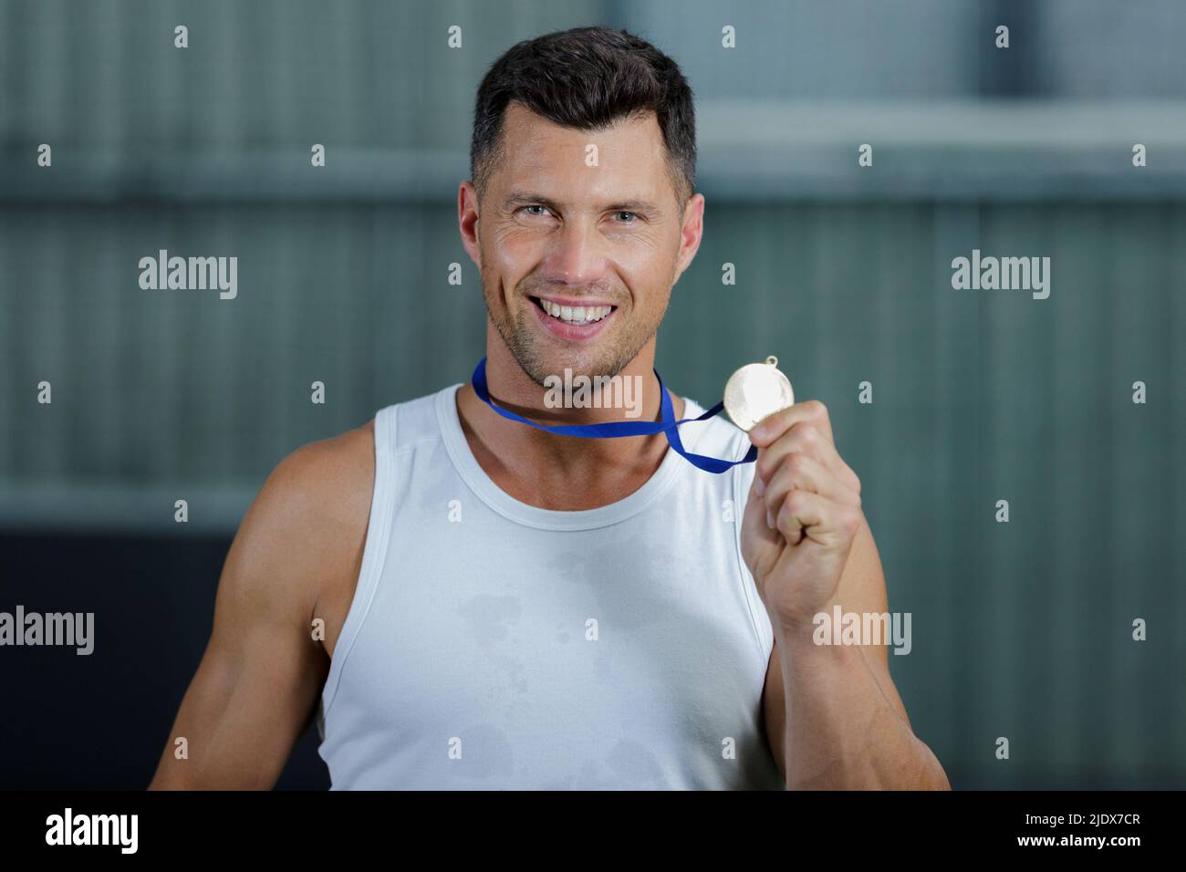 sporty man showing his medal Stock Photo - Alamy