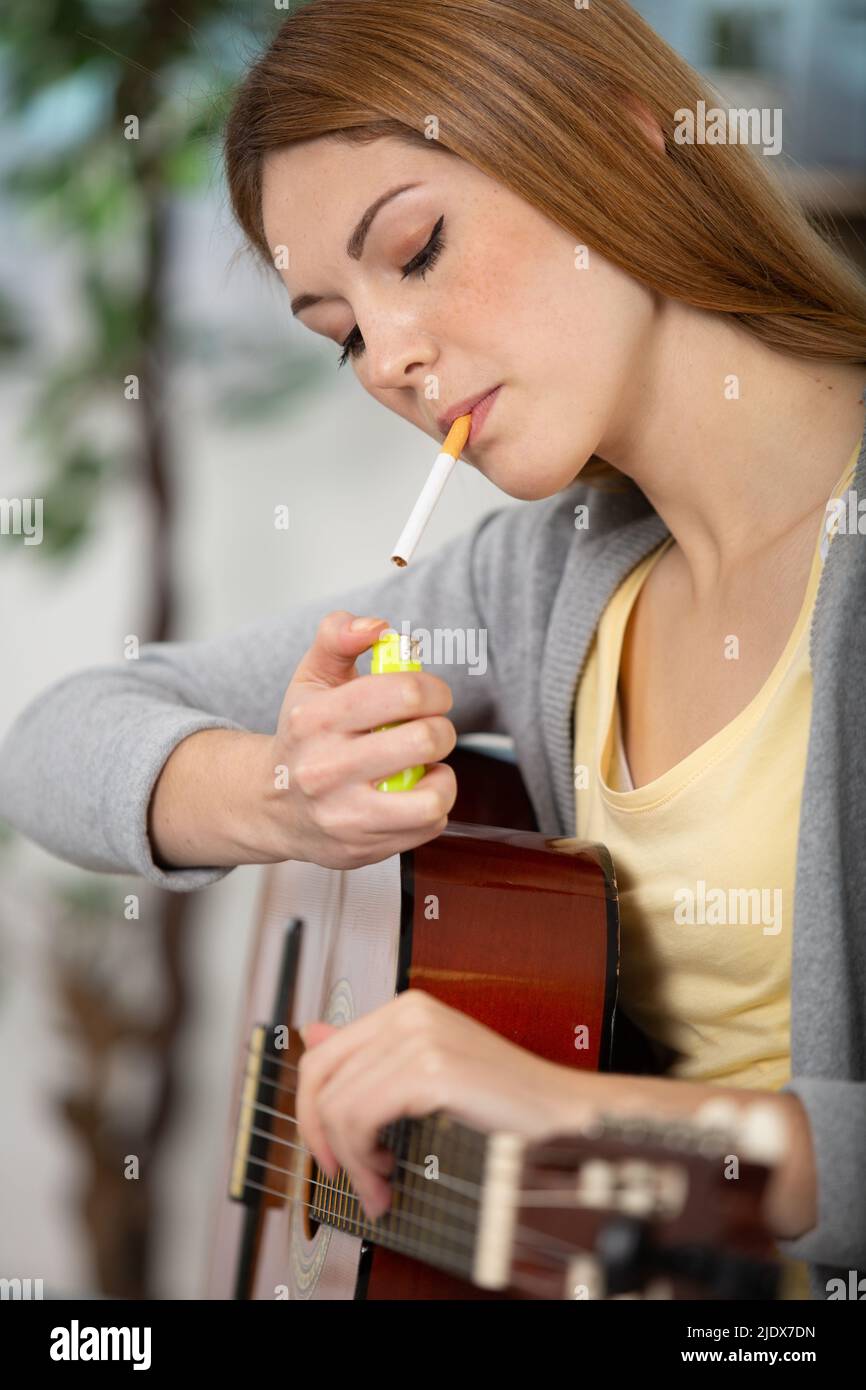 Beautiful woman lighting cigarette hi-res stock photography and images ...