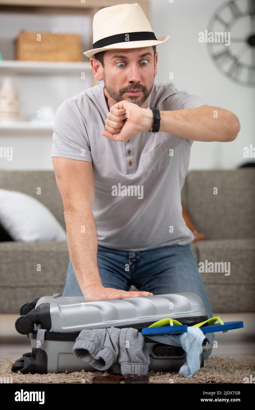 man packing suitcase is running late Stock Photo - Alamy
