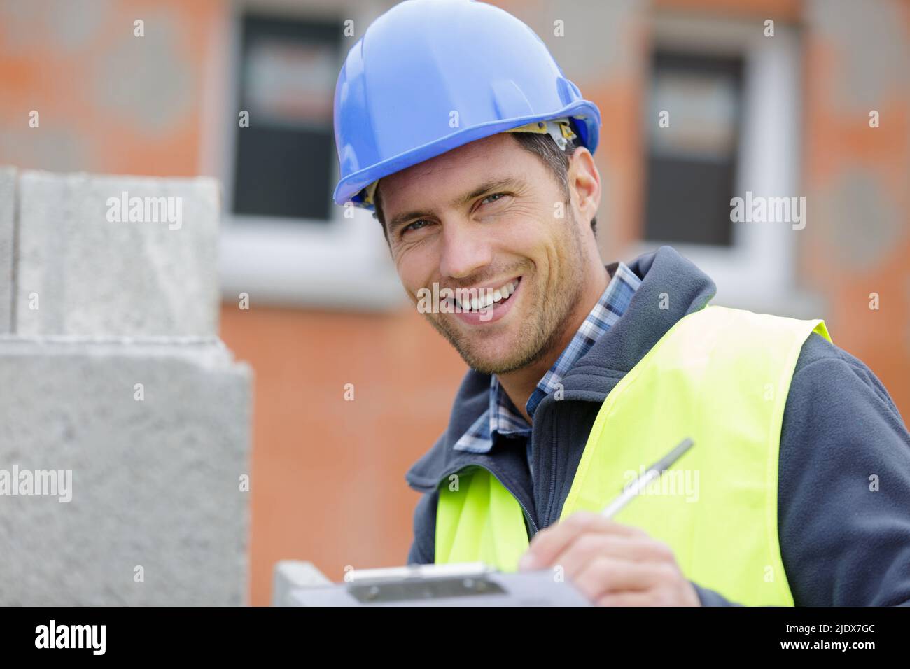 a cheerful constructor worker is smiling Stock Photo - Alamy