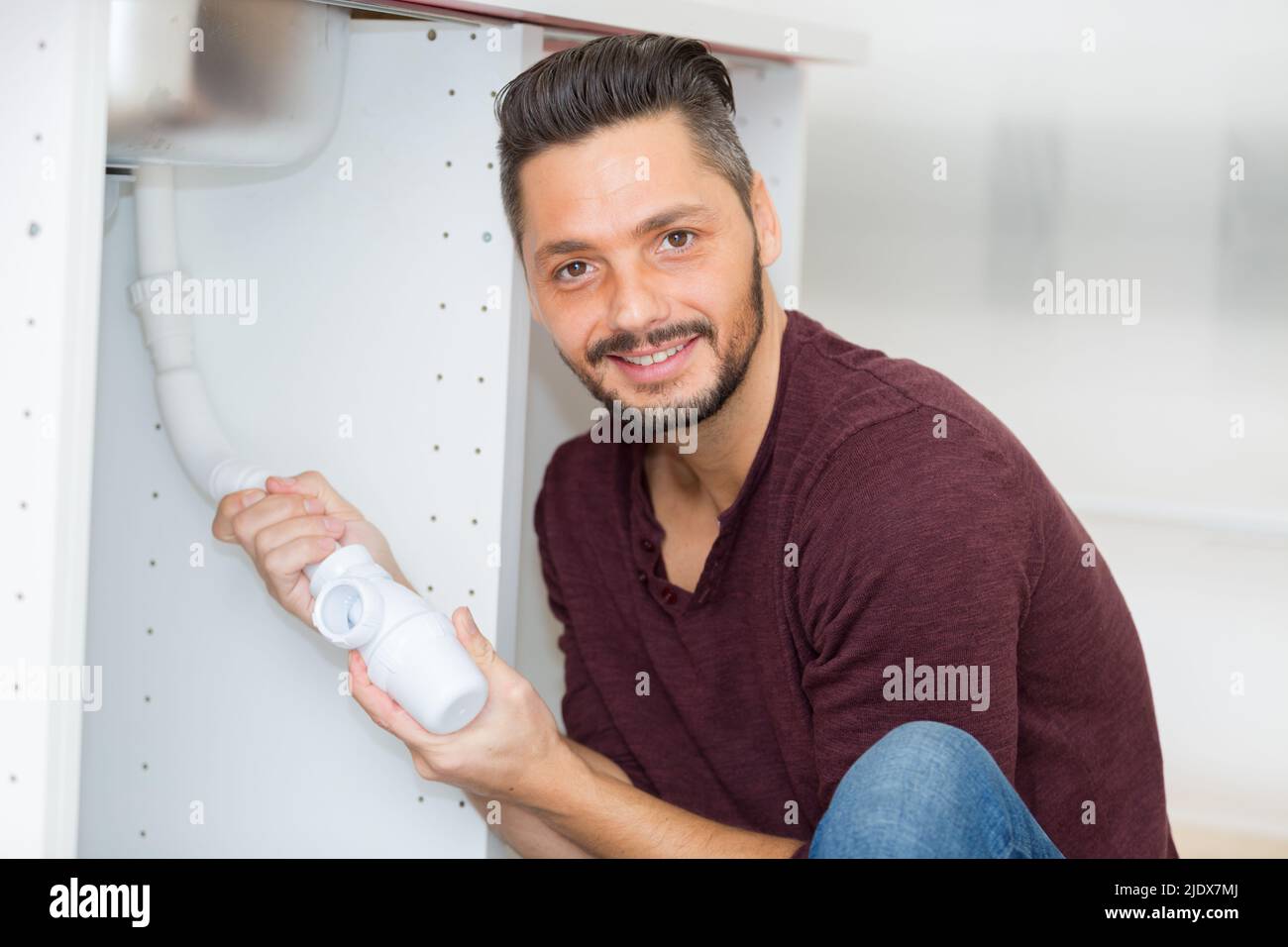 portrait of man fitting waste pipe on sink Stock Photo - Alamy