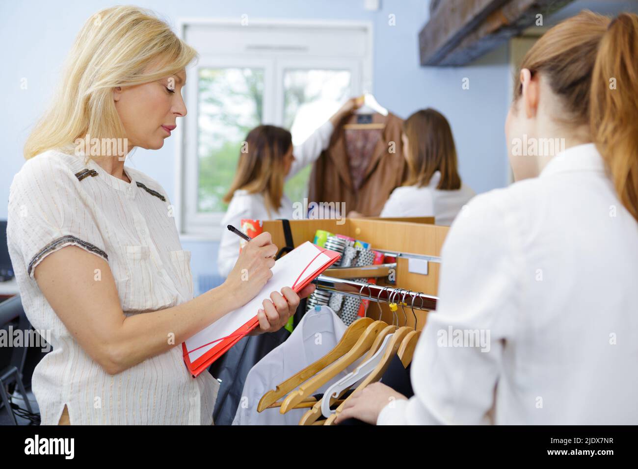 shop assistant with clipboard Stock Photo - Alamy