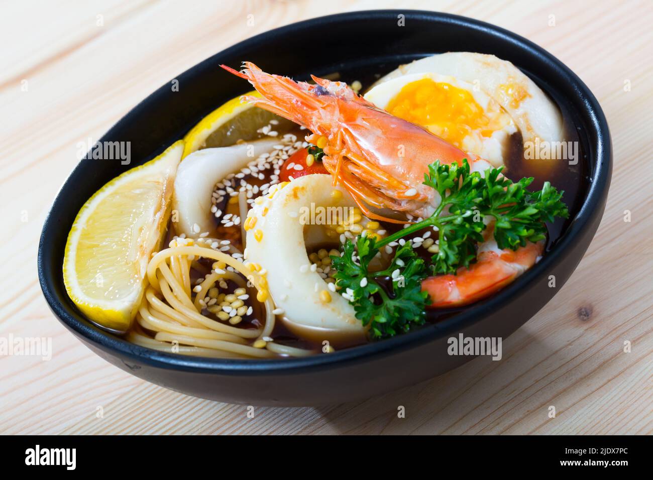 Asian cuisine spicy soup with squid Stock Photo - Alamy