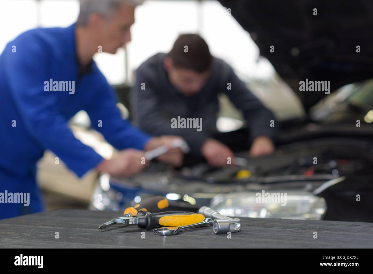 student with instructor repairing a car during apprenticeship Stock ...