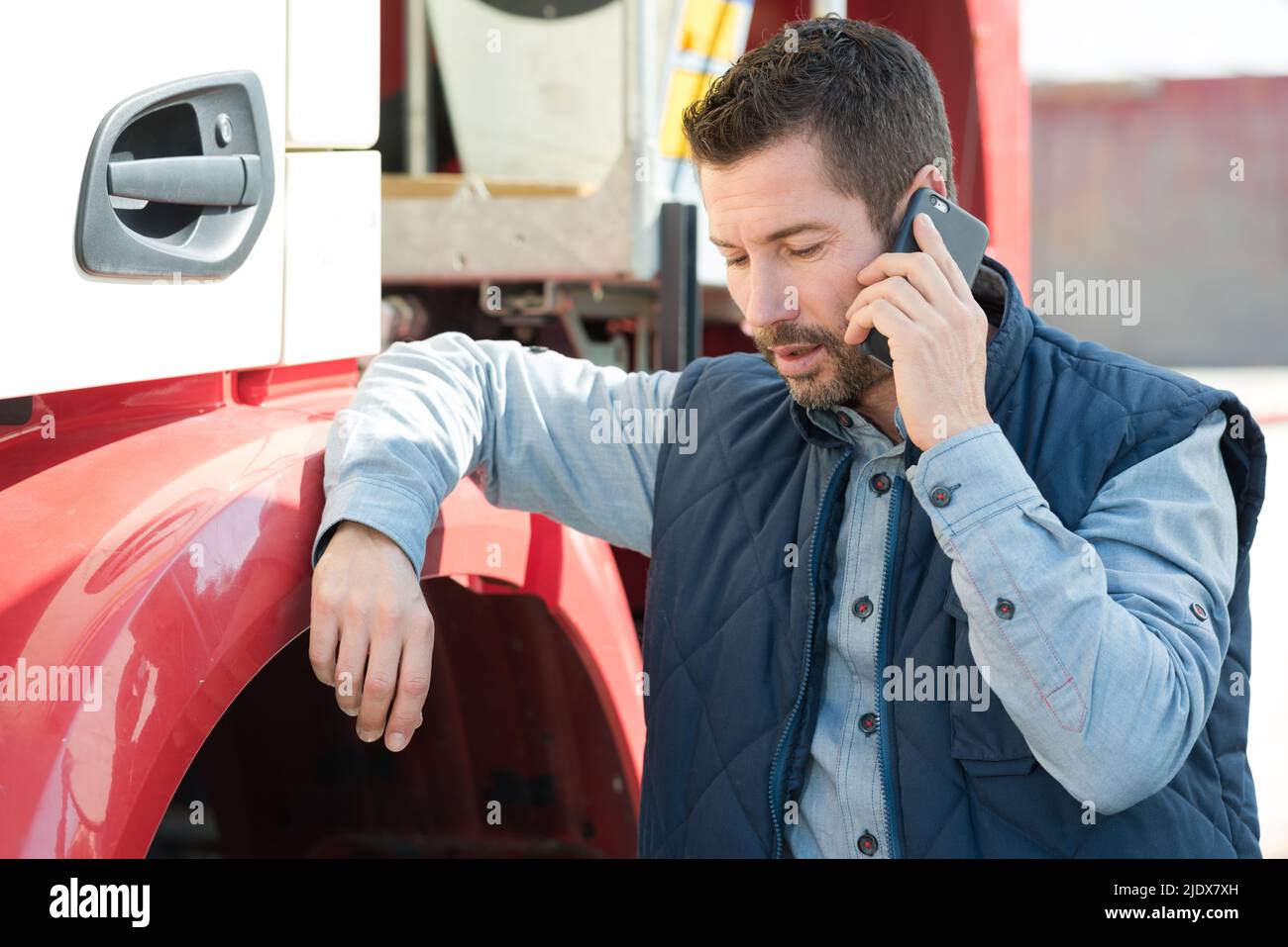 truck driver tending a client on the phone Stock Photo - Alamy