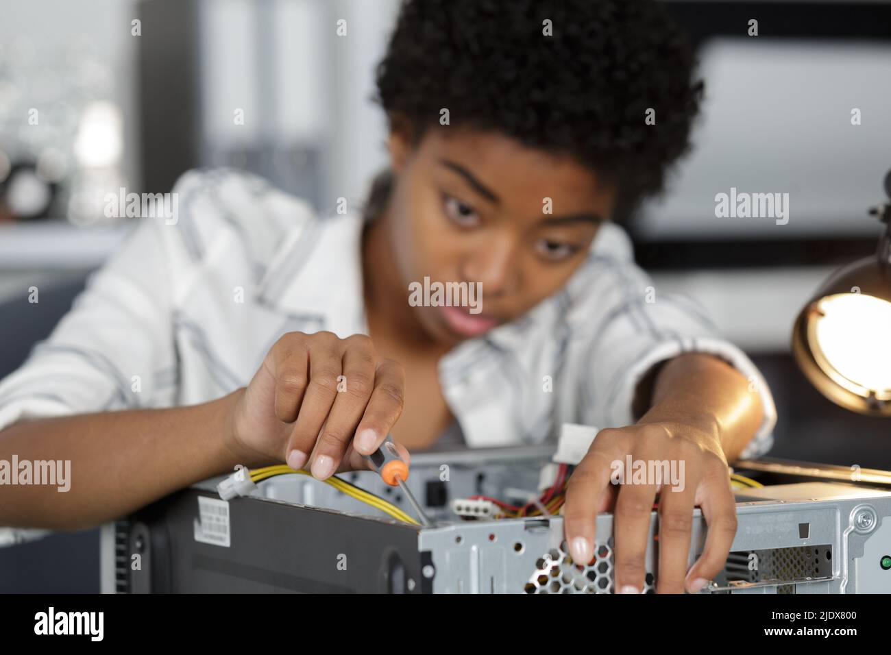 Female computer engineer repairing computer hi-res stock photography ...