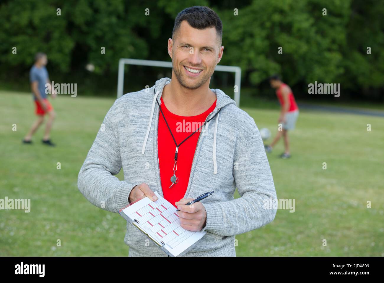 confident soccer coach posing for photography Stock Photo - Alamy