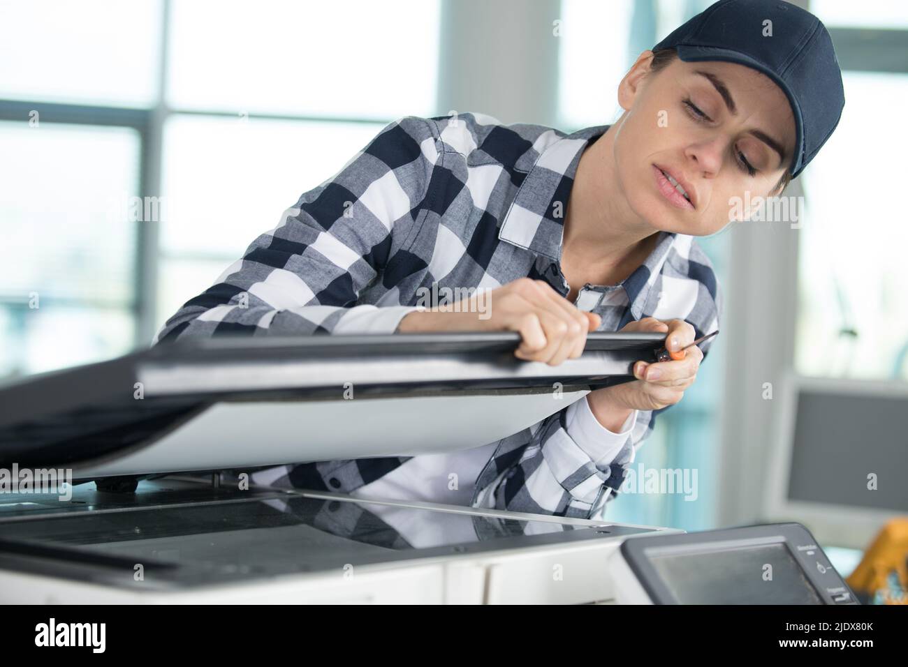 a woman is fixing the printer Stock Photo - Alamy
