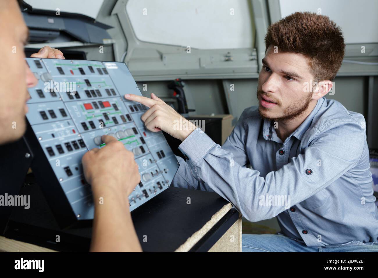 man pointing at buttons of control panel Stock Photo - Alamy