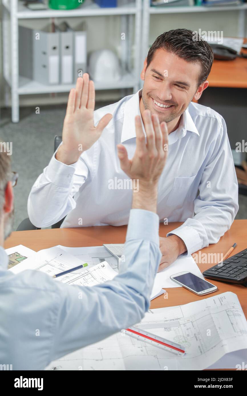 Two men about to do a high five Stock Photo - Alamy