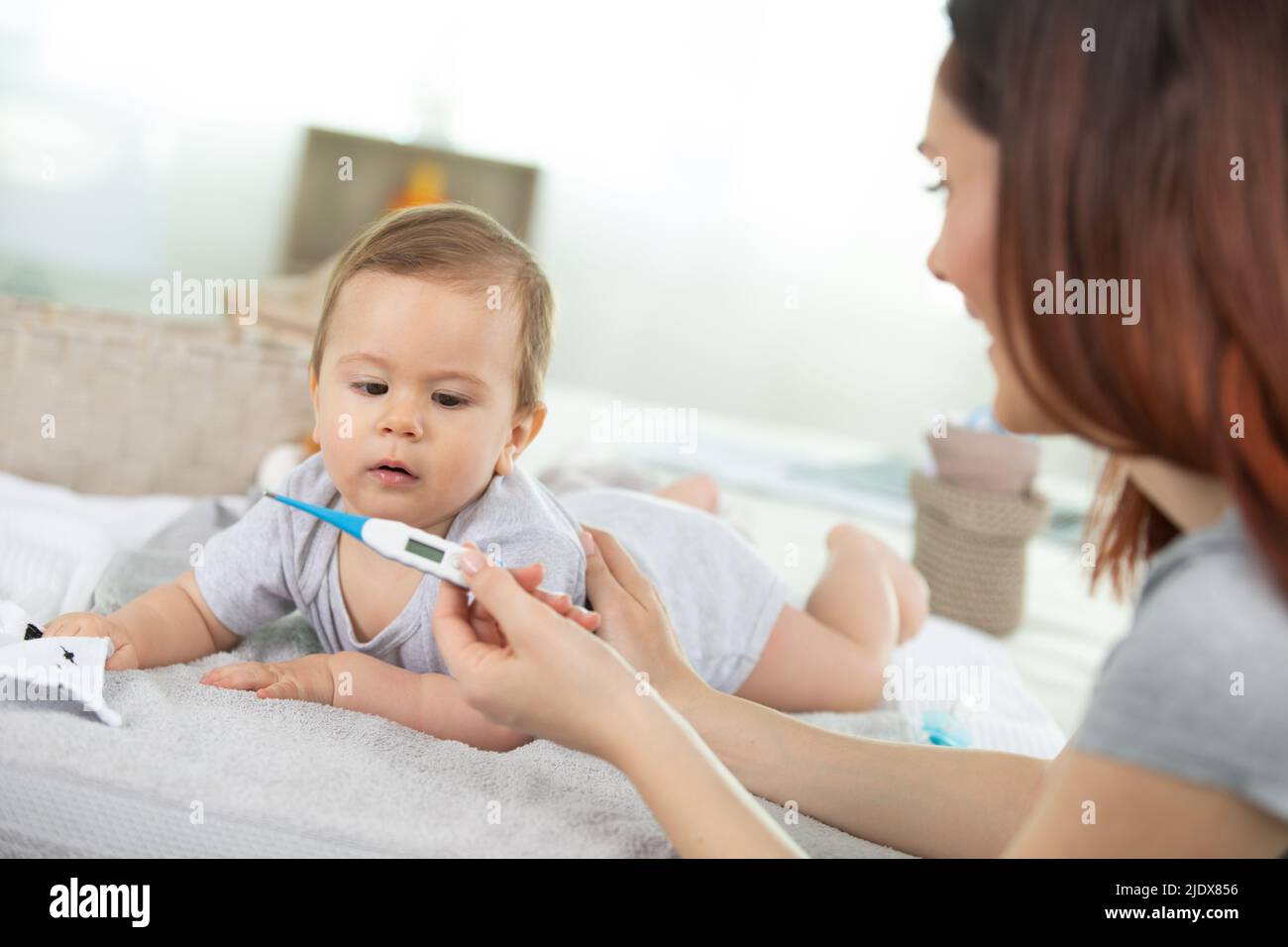 kid with high fever and mother taking temperature Stock Photo - Alamy