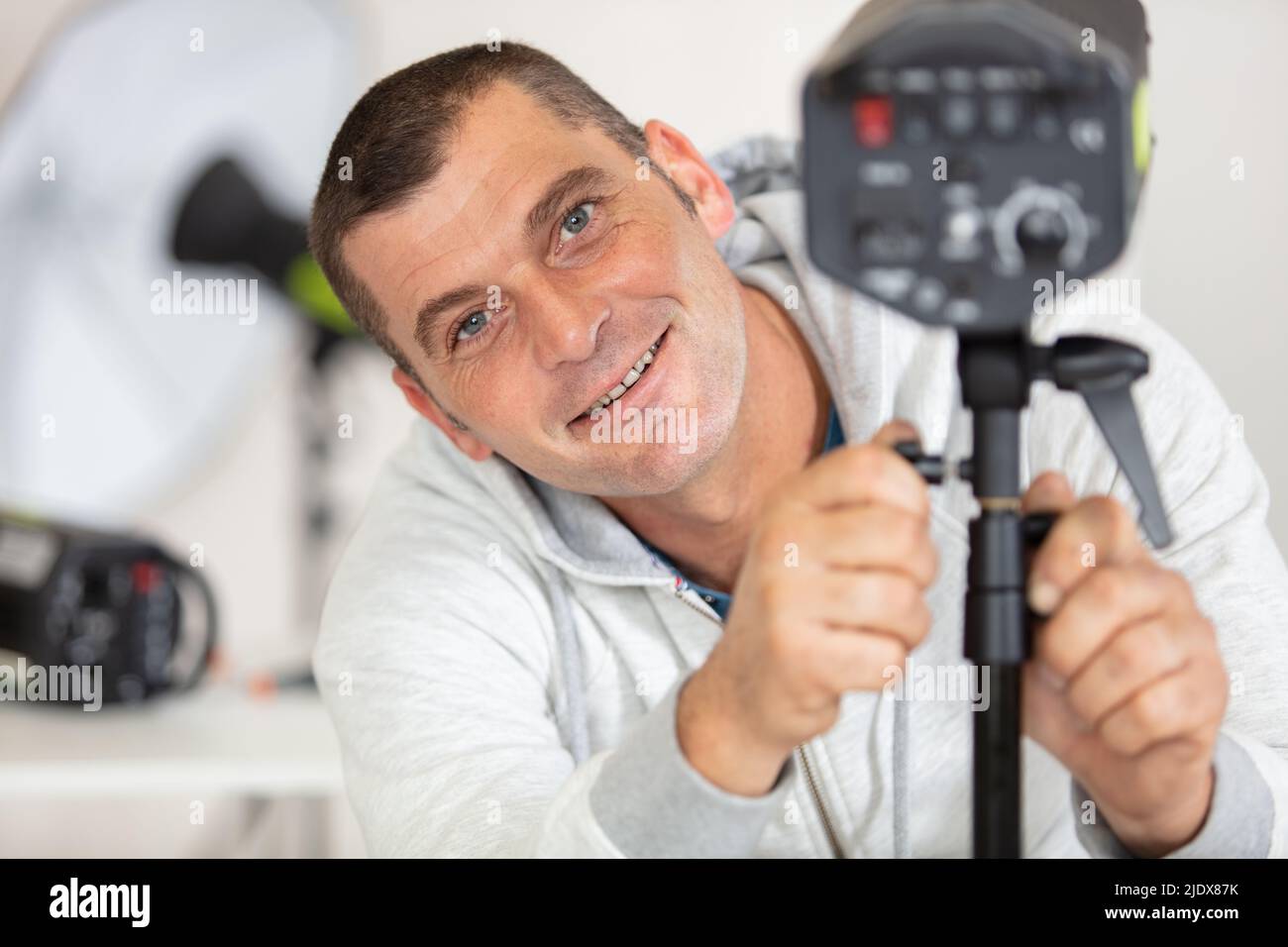 photographer adjusting lighting in a photographic studio Stock Photo ...